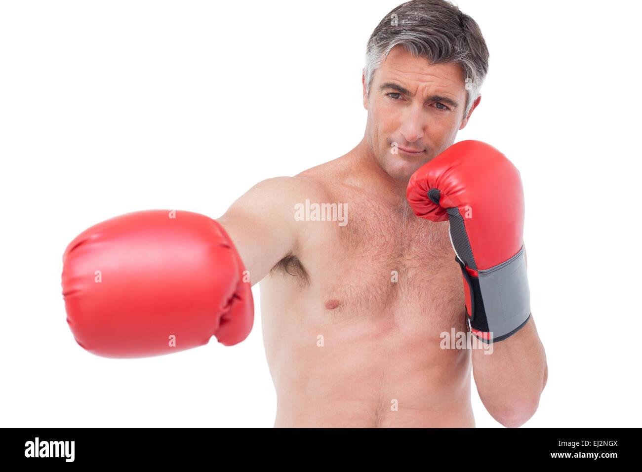 Fit man punching with boxing gloves Stock Photo - Alamy