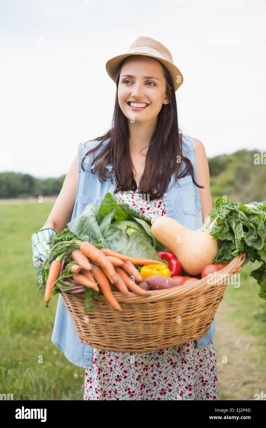 Pretty woman with basket of veg Stock Photo - Alamy