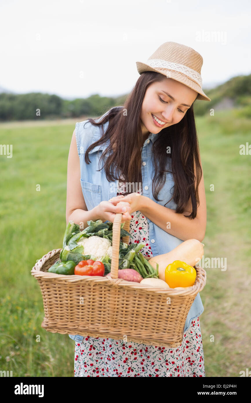 Pretty woman with basket of veg Stock Photo - Alamy