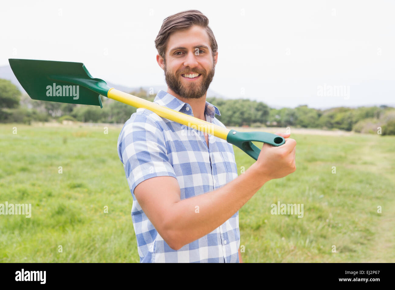 Happy man with his shovel Stock Photo - Alamy