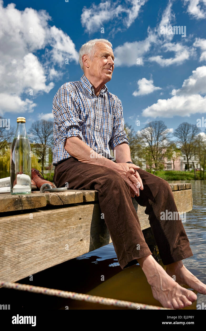 Elderly man sitting barefoot on hi-res stock photography and images - Alamy