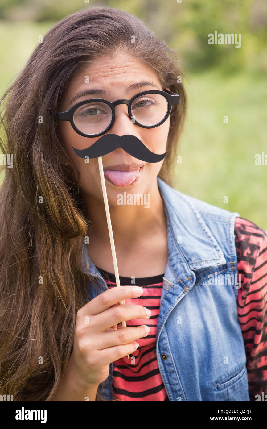 Pretty brunette with fake mustache Stock Photo - Alamy