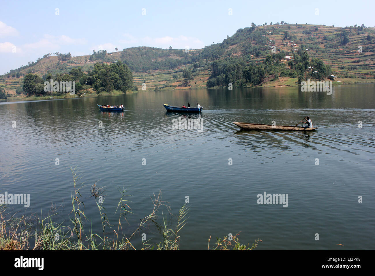 Passengers take a boat ride on lake Bunyonyi is western Uganda Stock ...