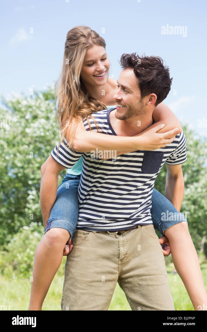 Cute couple having fun in park Stock Photo - Alamy