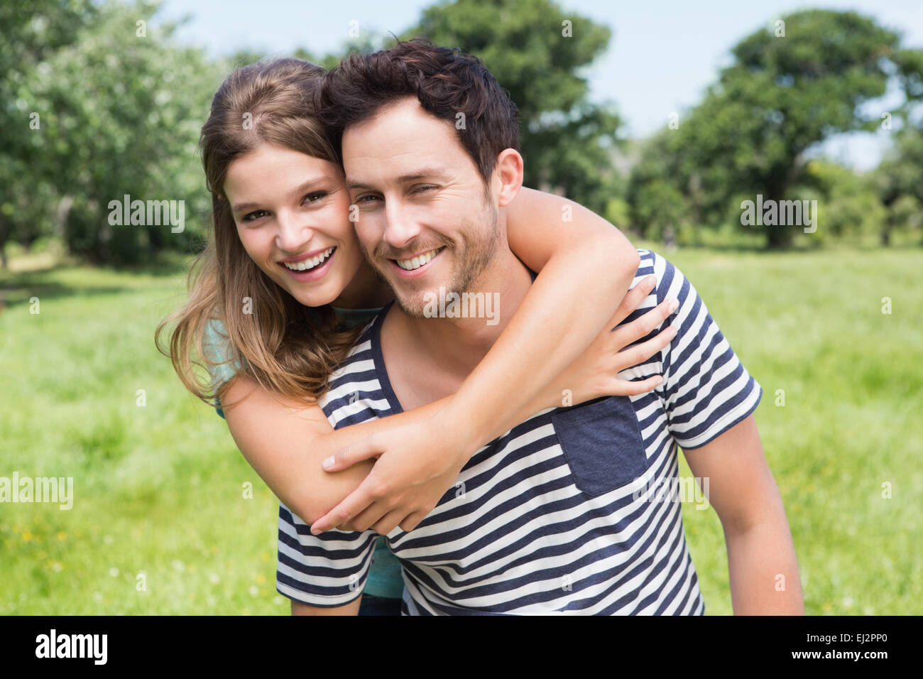 Cute couple having fun in park Stock Photo - Alamy