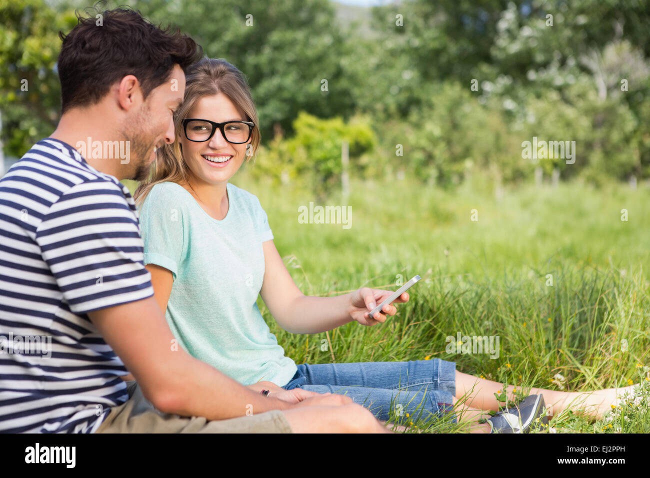 Cute couple relaxing in the park Stock Photo - Alamy