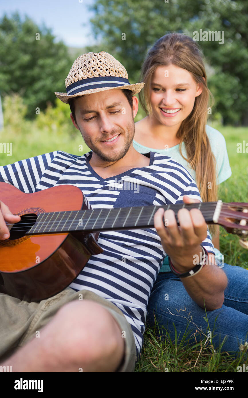 Cute couple relaxing in the park Stock Photo - Alamy