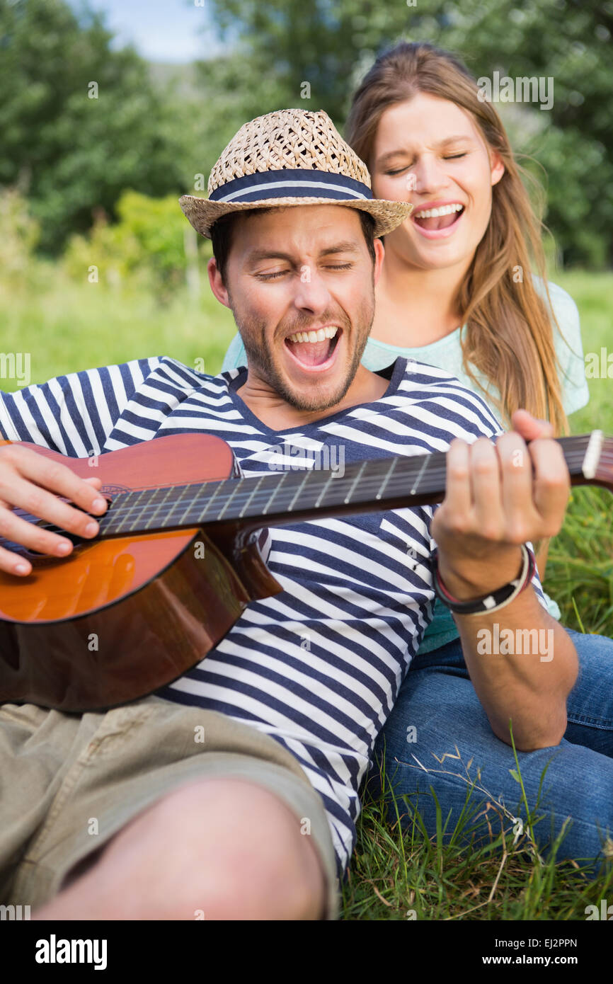 Cute couple relaxing in the park Stock Photo - Alamy