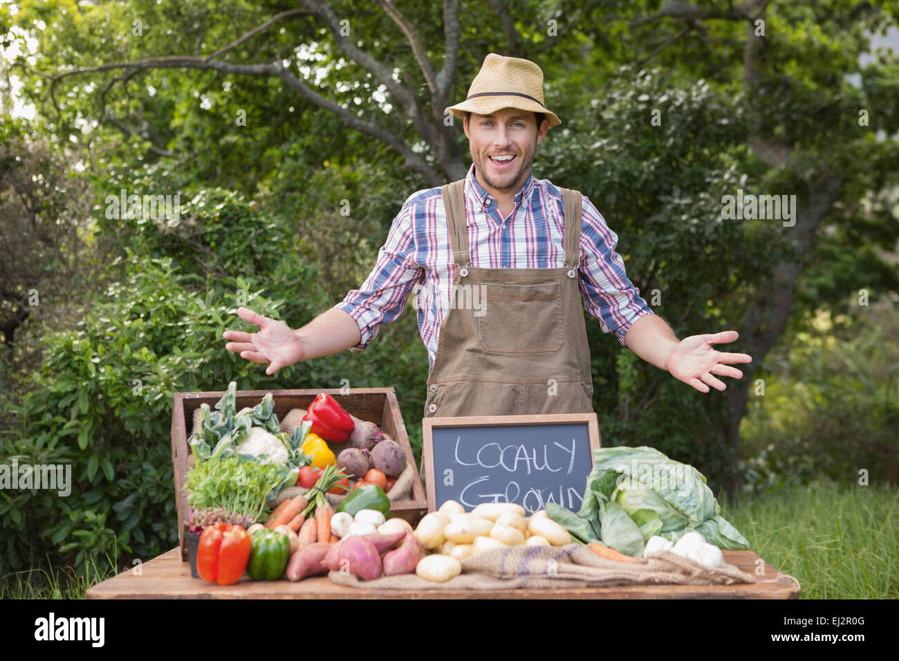 Happy farmer showing his produce Stock Photo - Alamy