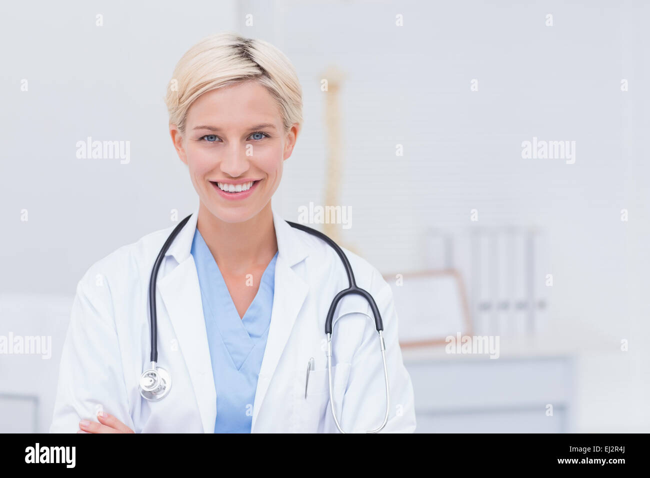 Confident female doctor smiling in clinic Stock Photo - Alamy