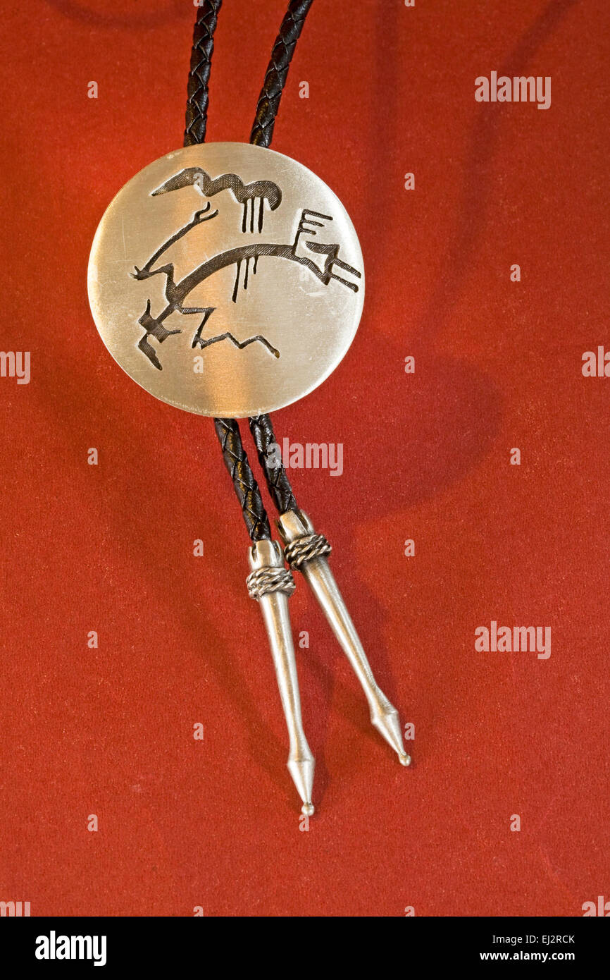 A Navajo Yei Bichei figure, or Rainbow God, on a man's bolo tie from ...