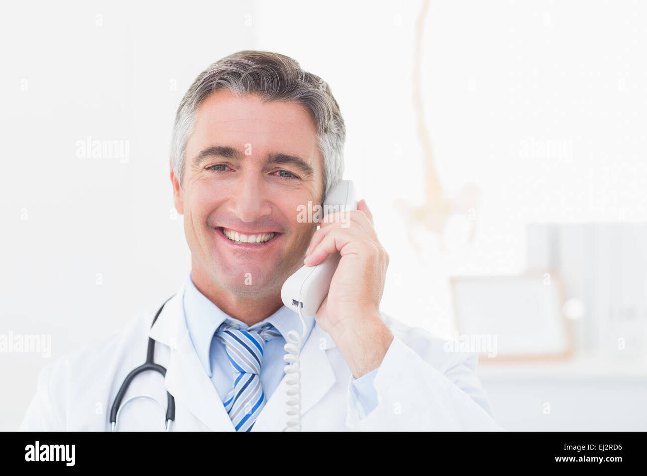 Doctor using landline phone in clinic Stock Photo - Alamy