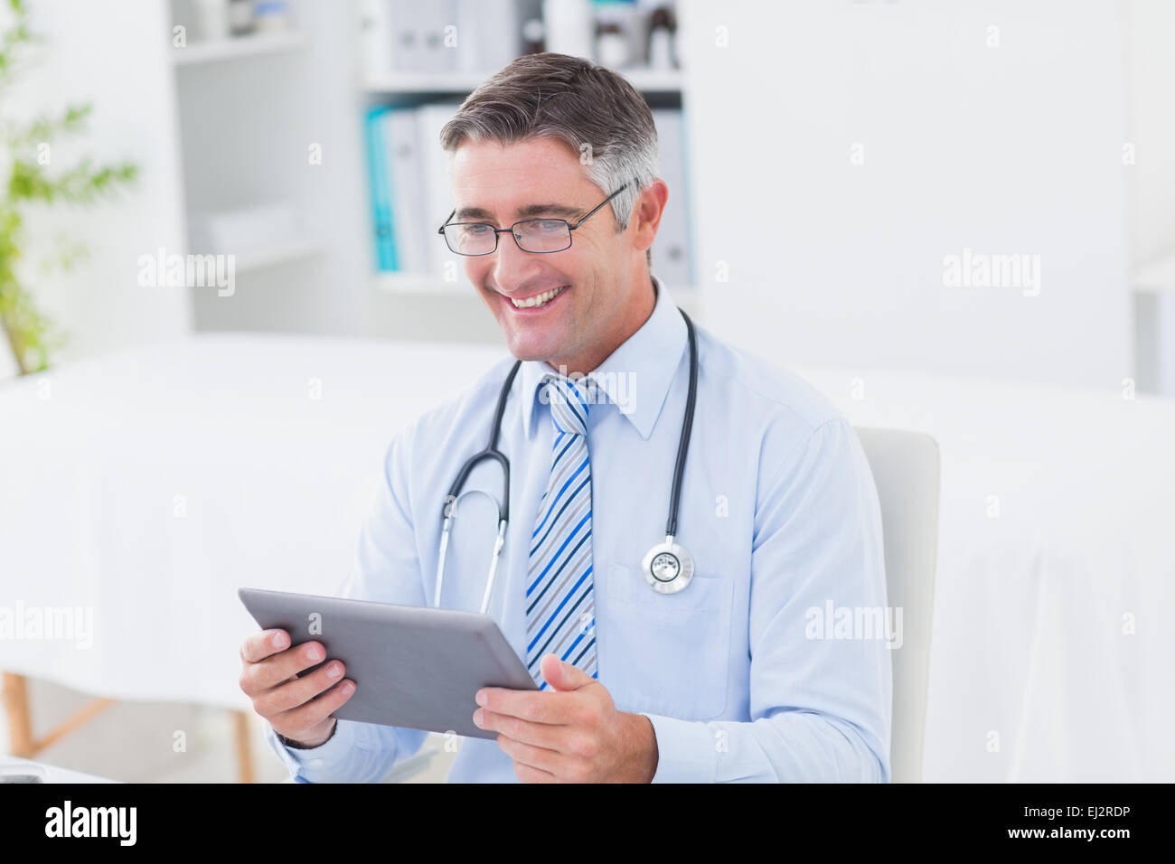 Male doctor using tablet computer Stock Photo - Alamy