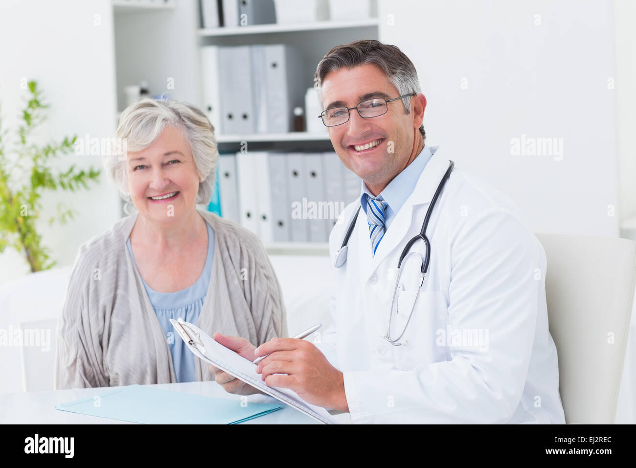 Female doctor examining document hi-res stock photography and images ...