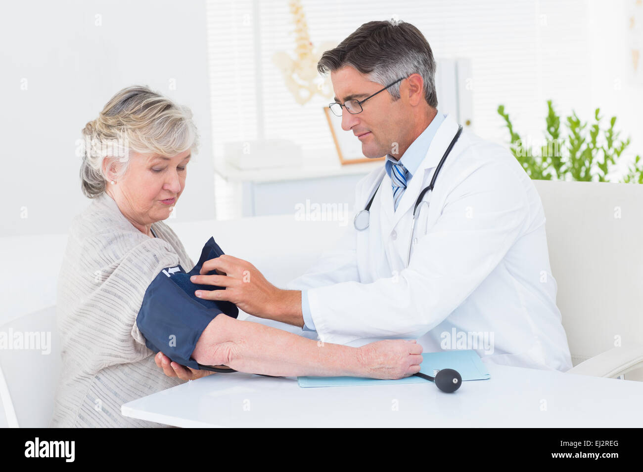 Doctor checking blood on hand hi-res stock photography and images - Alamy