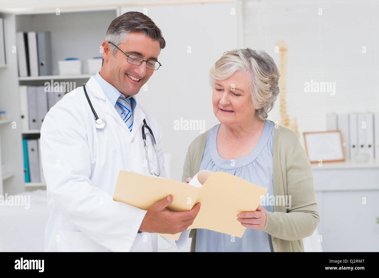 Doctor discussing patient report hi-res stock photography and images ...