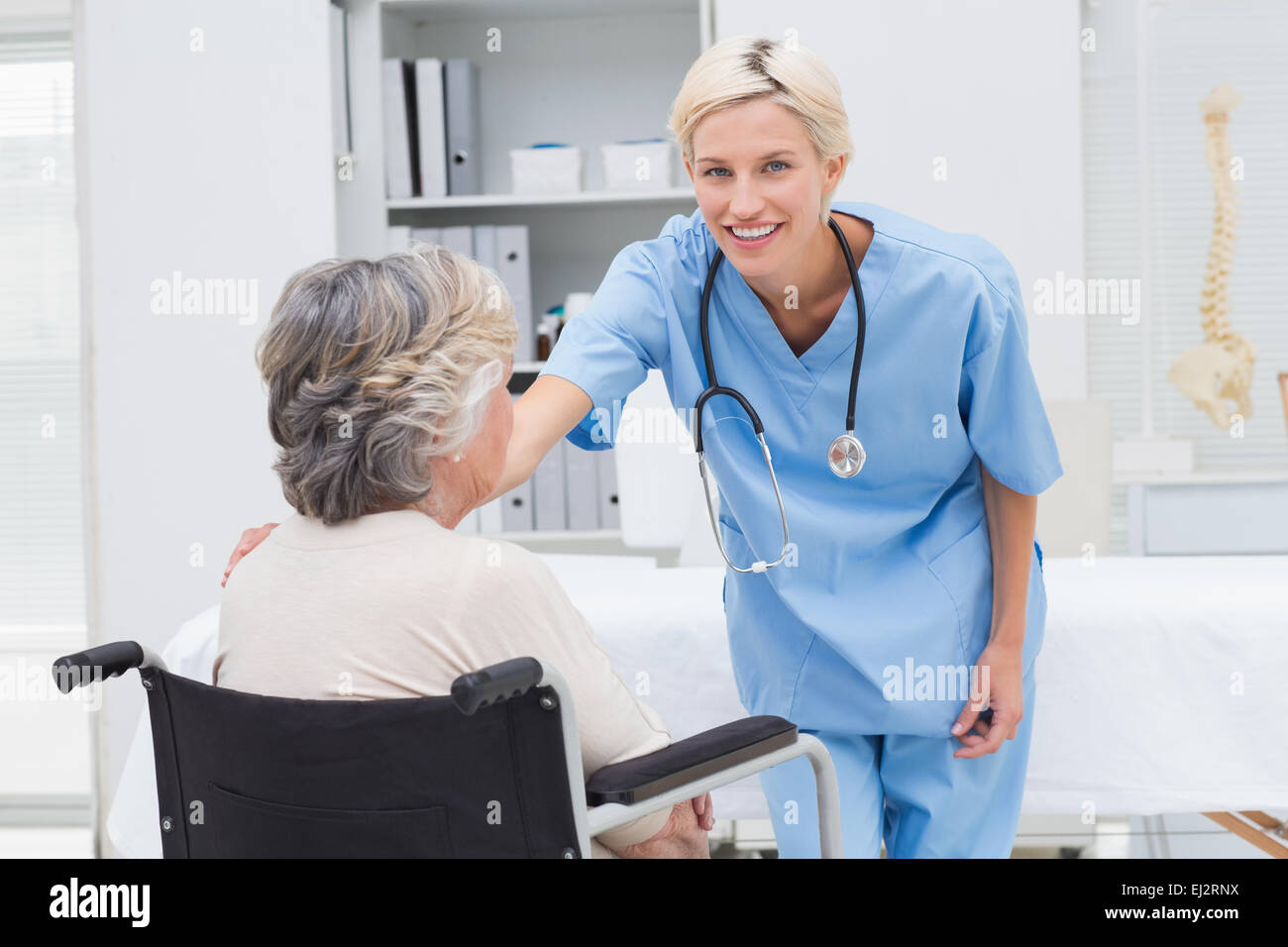 Portrait of nurse consoling patient sitting on wheelchair Stock Photo ...