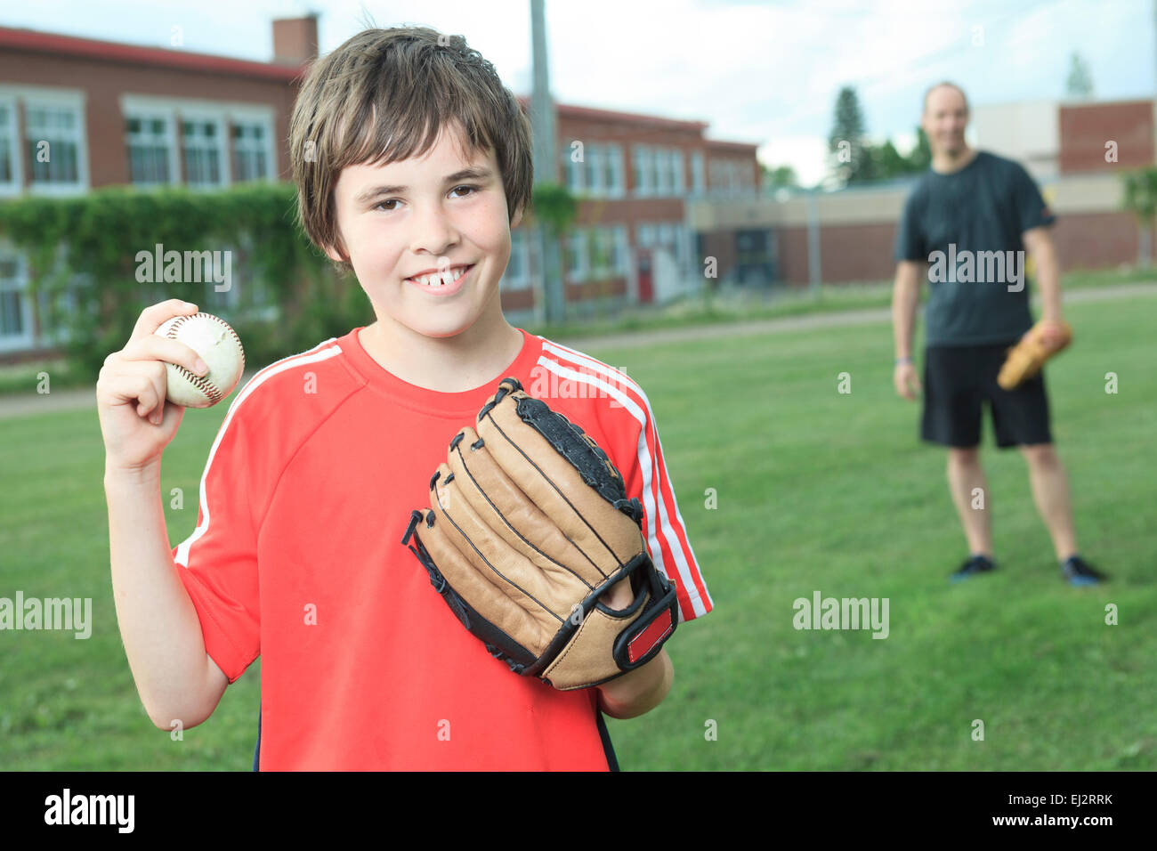 Portrait of a young baseball player in a field Stock Photo - Alamy