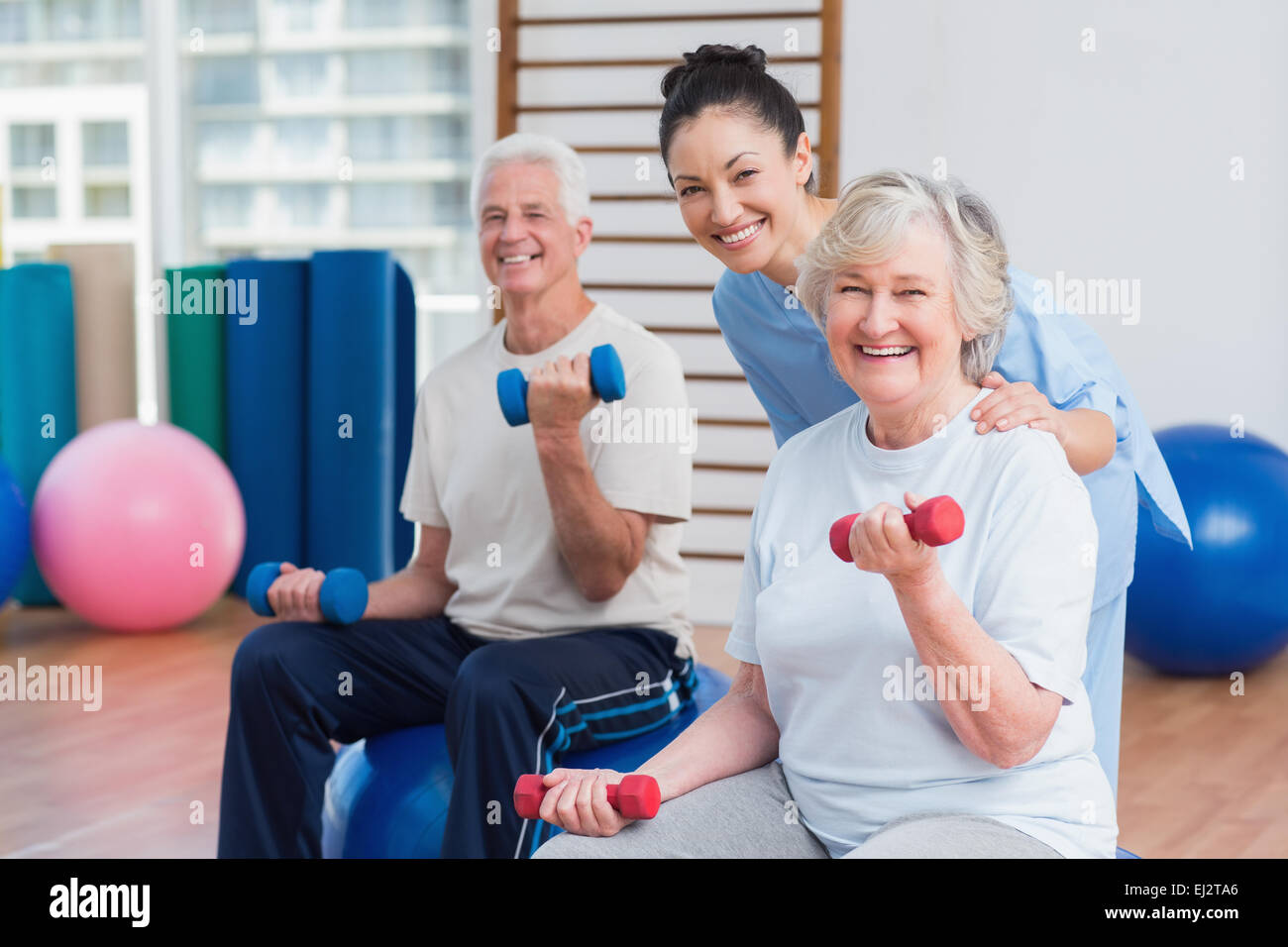 Portrait of happy instructor with senior couple Stock Photo - Alamy