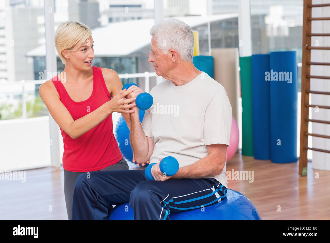 Female coach guiding senior man hi-res stock photography and images - Alamy