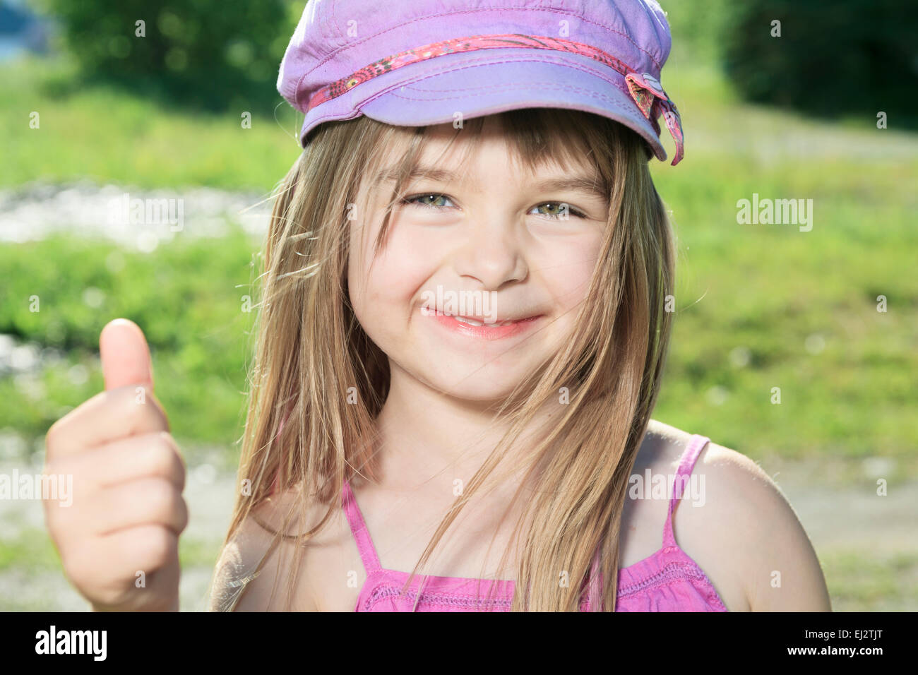 Little girl riding a bike on the country road Stock Photo - Alamy