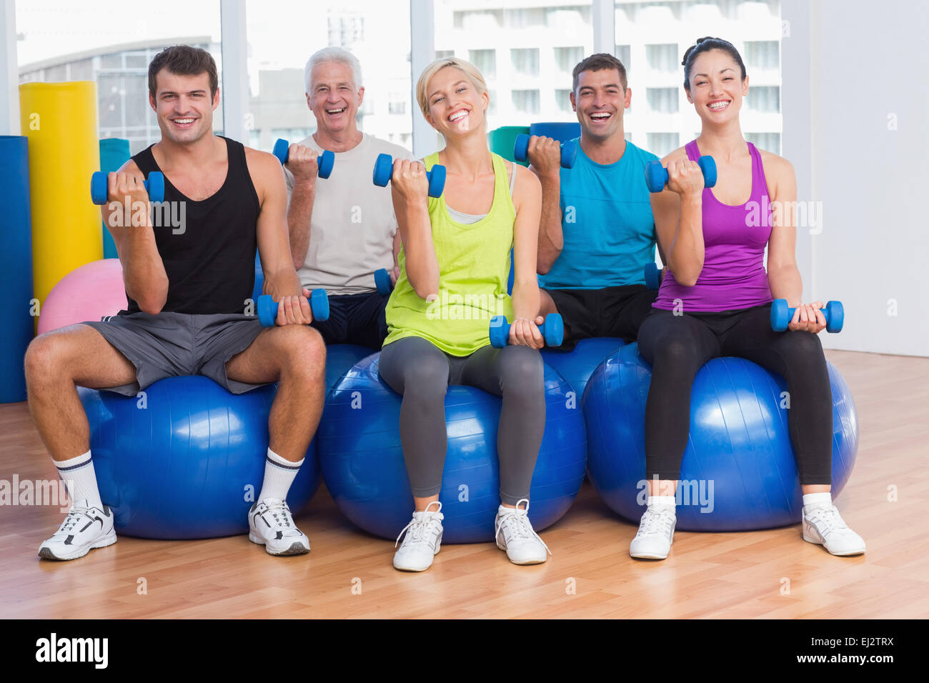 People working out on exercise balls at gym class Stock Photo - Alamy