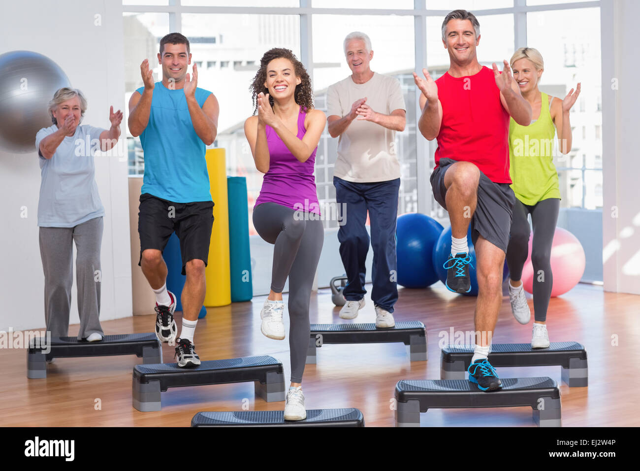 People performing step aerobics exercise in gym Stock Photo - Alamy