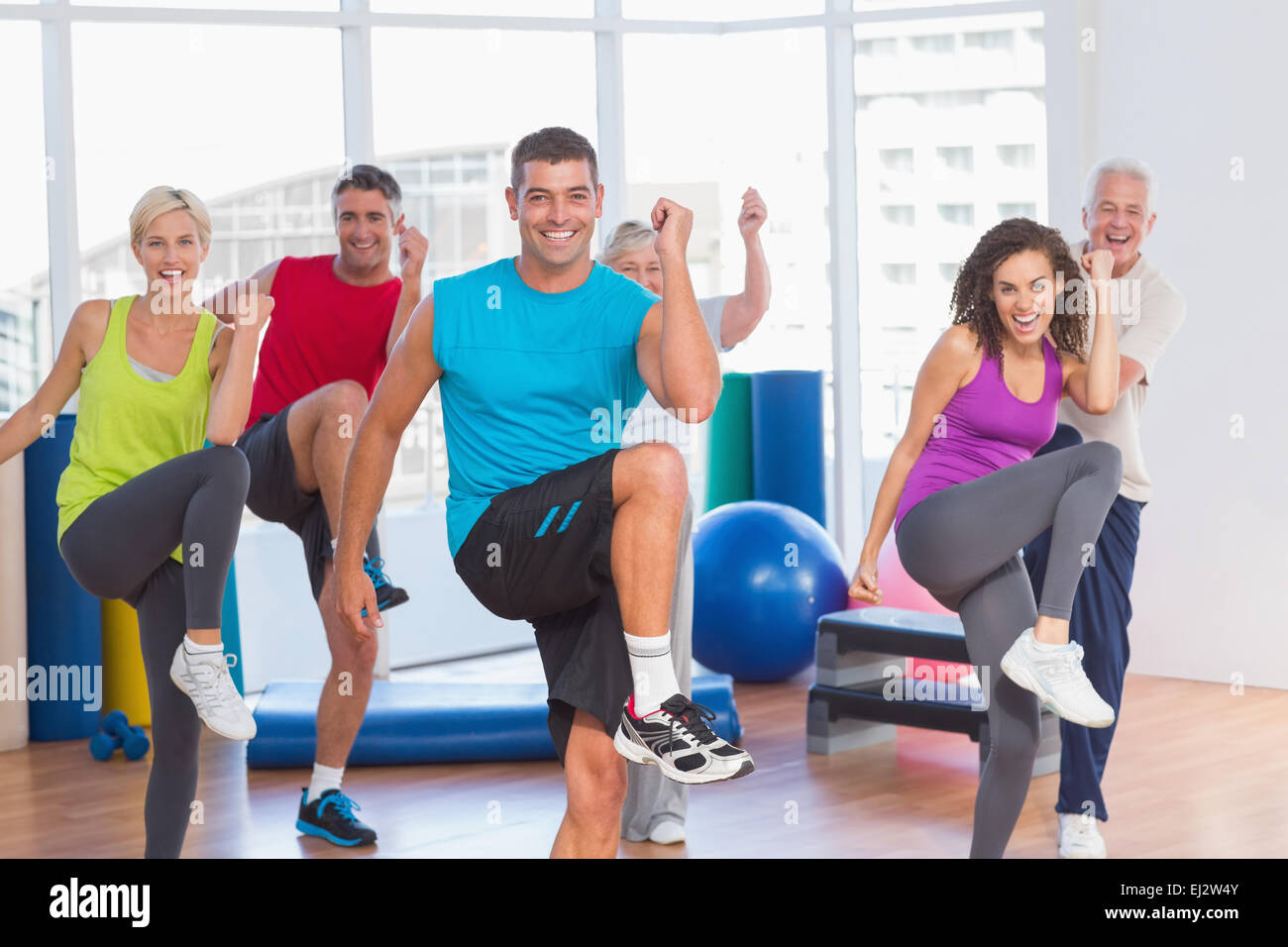 Group performing fitness exercises hi-res stock photography and images ...