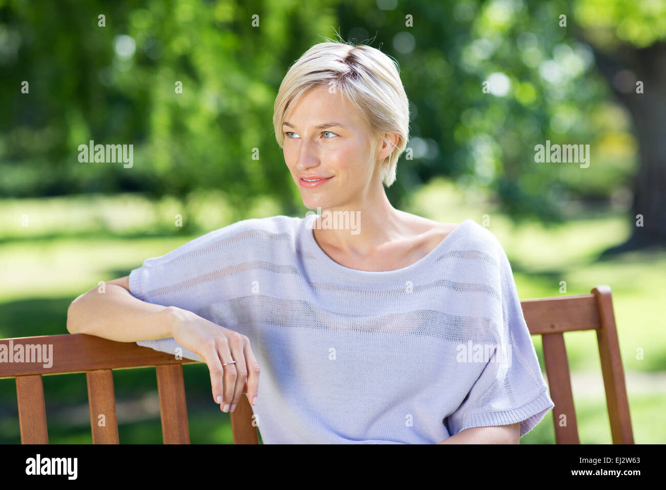 Blonde sitting on park hi-res stock photography and images - Alamy
