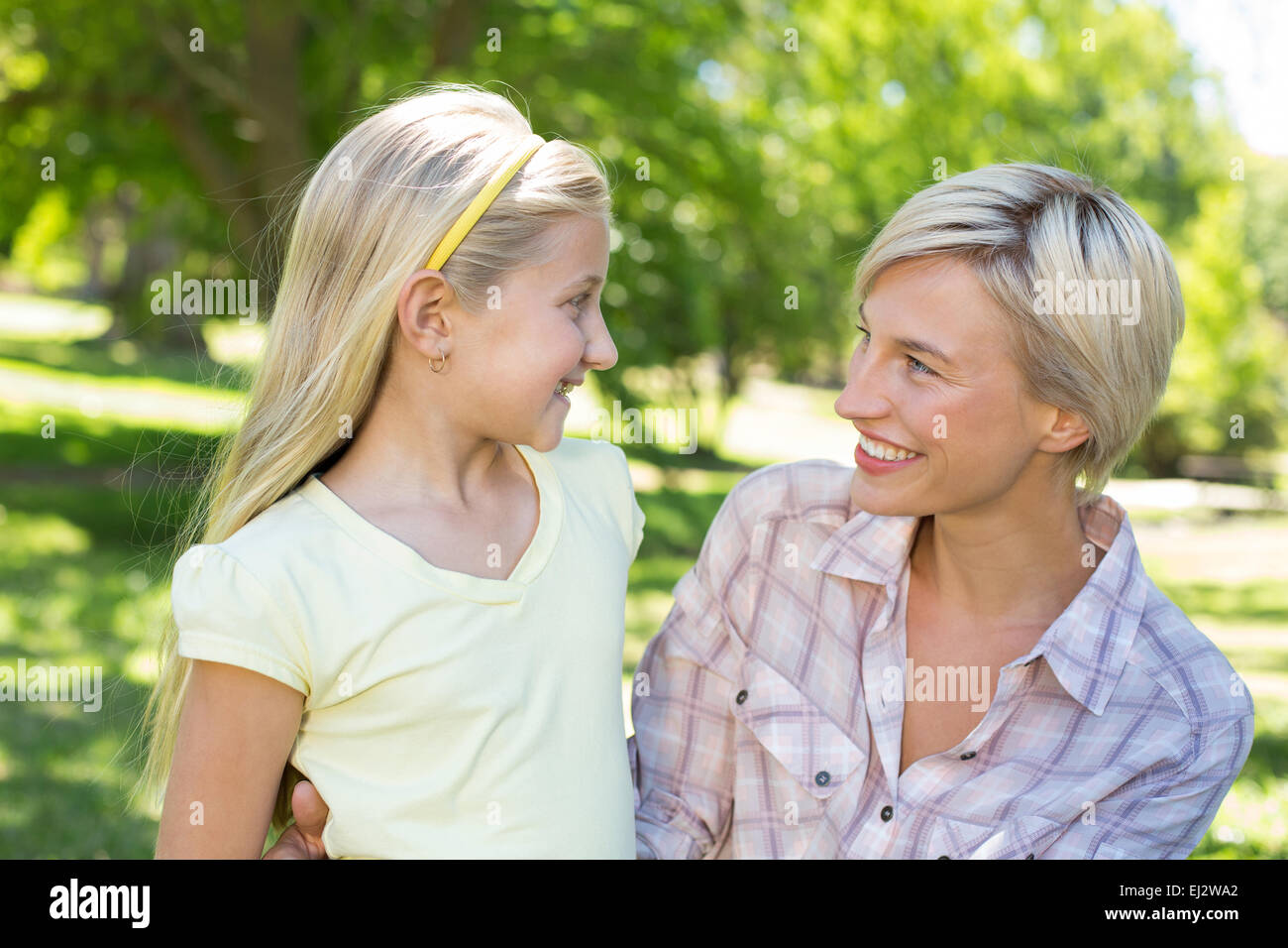 Pretty blonde with her daughter in the park Stock Photo - Alamy