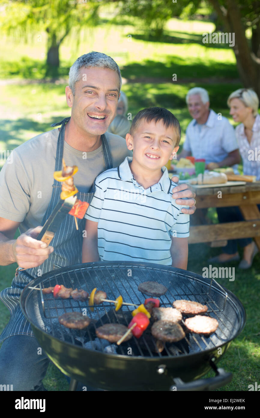 Happy father doing barbecue with his son Stock Photo - Alamy