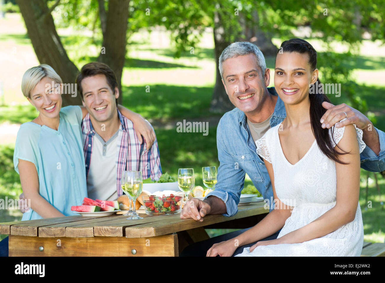 Happy couples smiling at the camera Stock Photo - Alamy