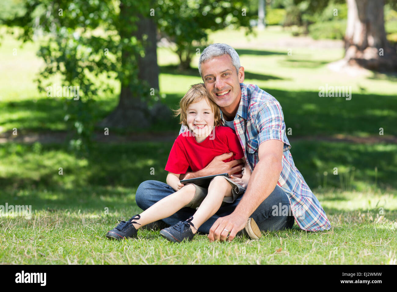 Happy father son using tablet hi-res stock photography and images - Alamy