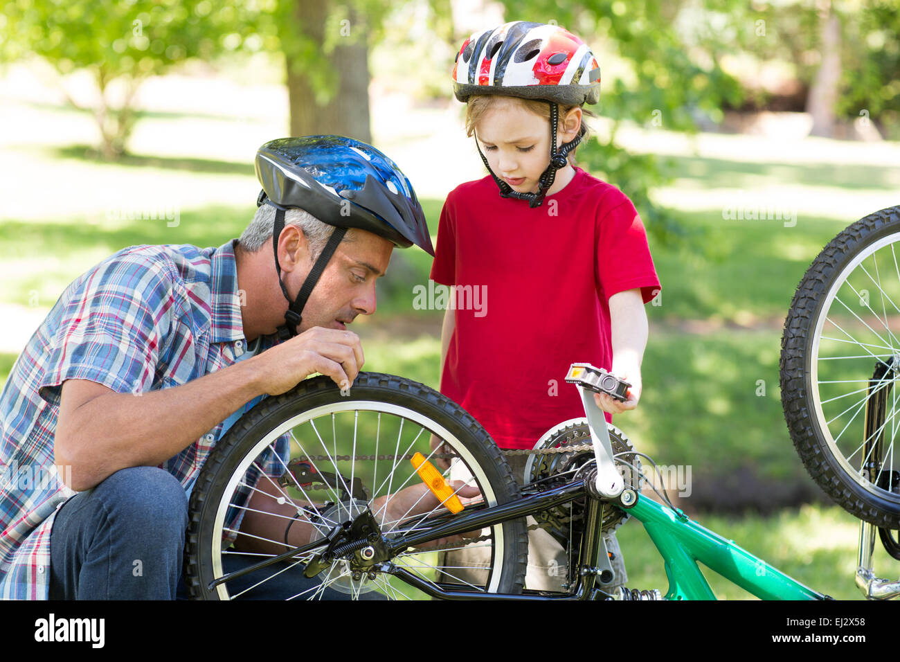 Father and son fixing a bike Stock Photo - Alamy