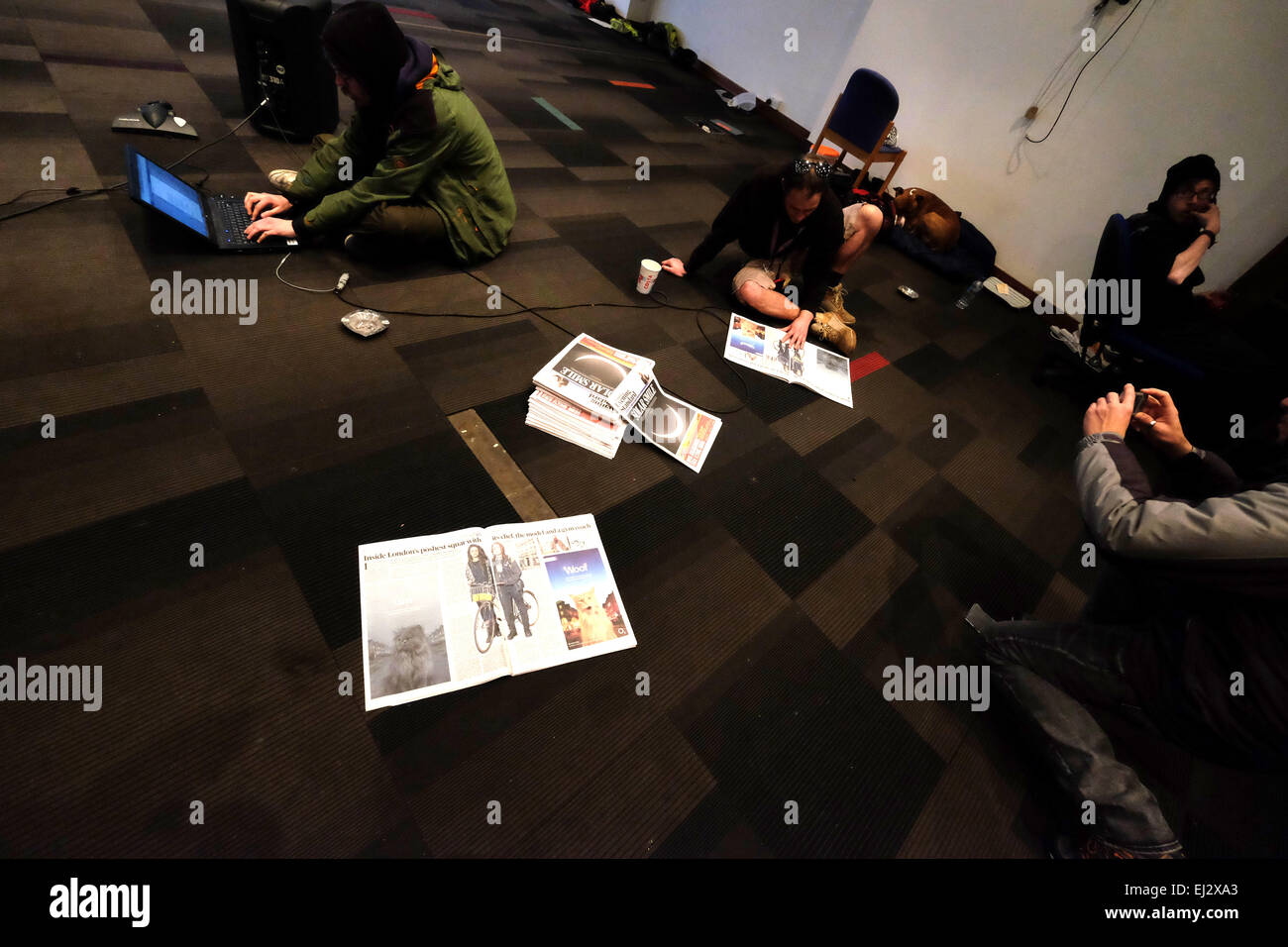 London, UK. 20th March, 2015. The Squatters read about themselves in ...