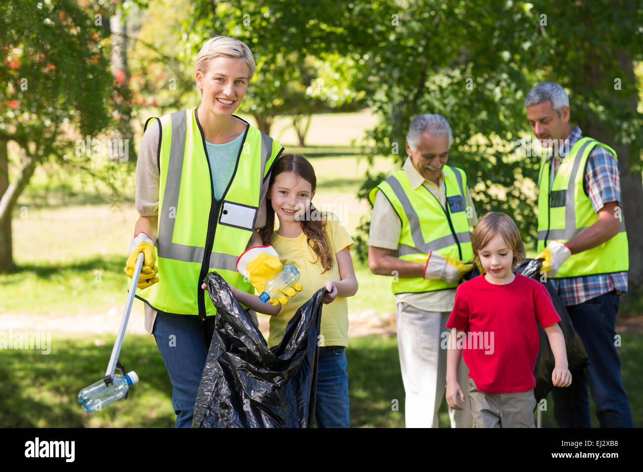 Happy family collecting rubbish Stock Photo - Alamy