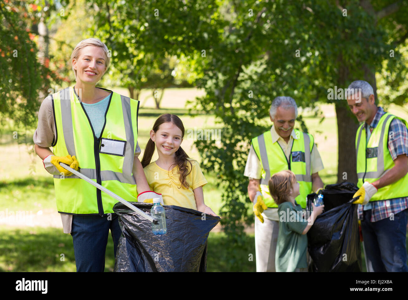 Happy family collecting rubbish Stock Photo - Alamy