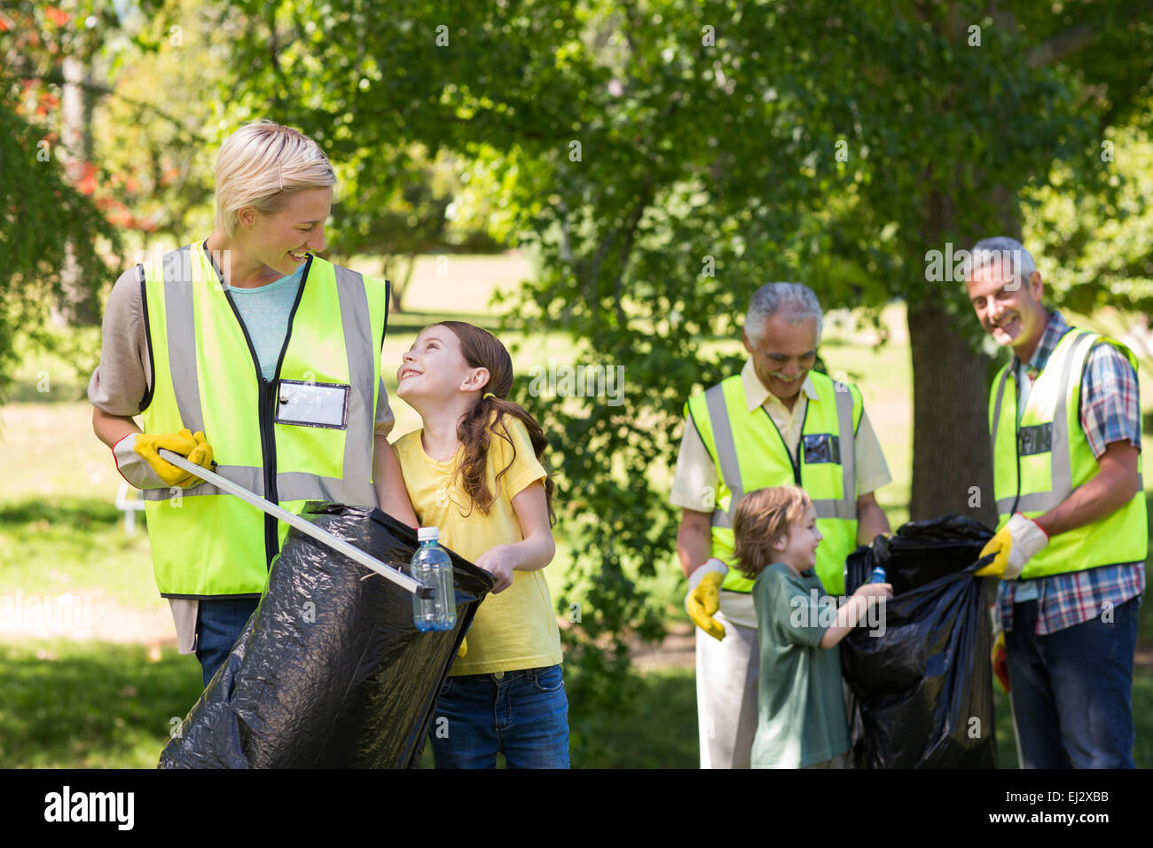 Happy family collecting rubbish Stock Photo - Alamy