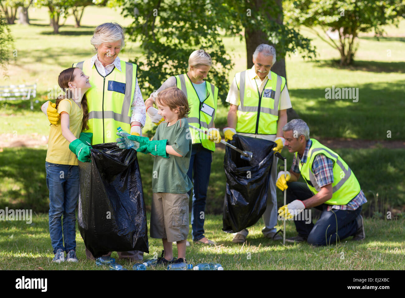 Happy family collecting rubbish Stock Photo - Alamy