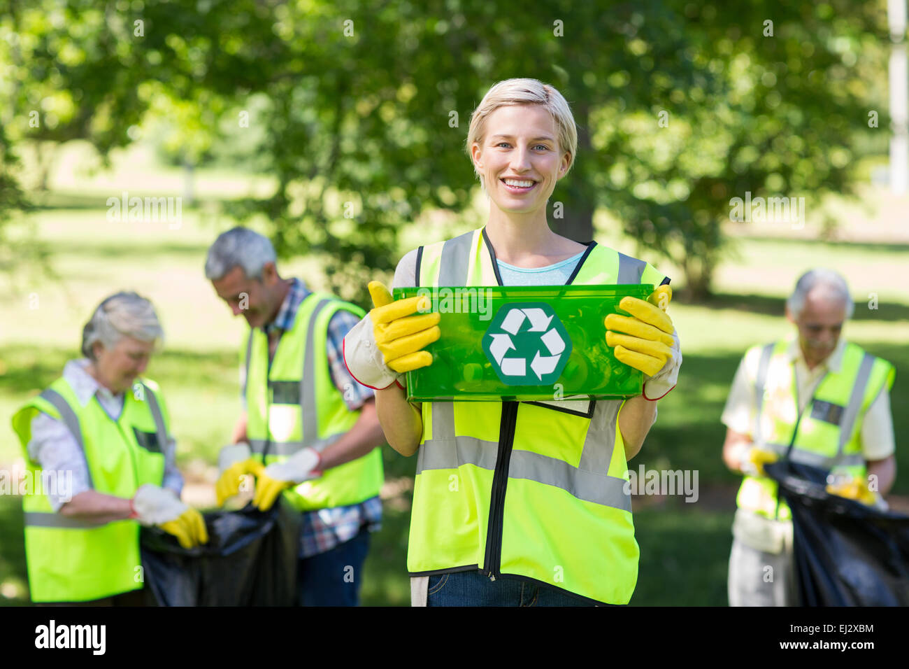 Happy mother holding recycling case Stock Photo - Alamy