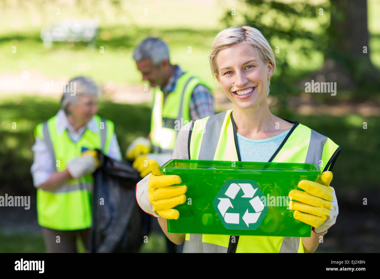 Happy mother holding recycling case Stock Photo - Alamy