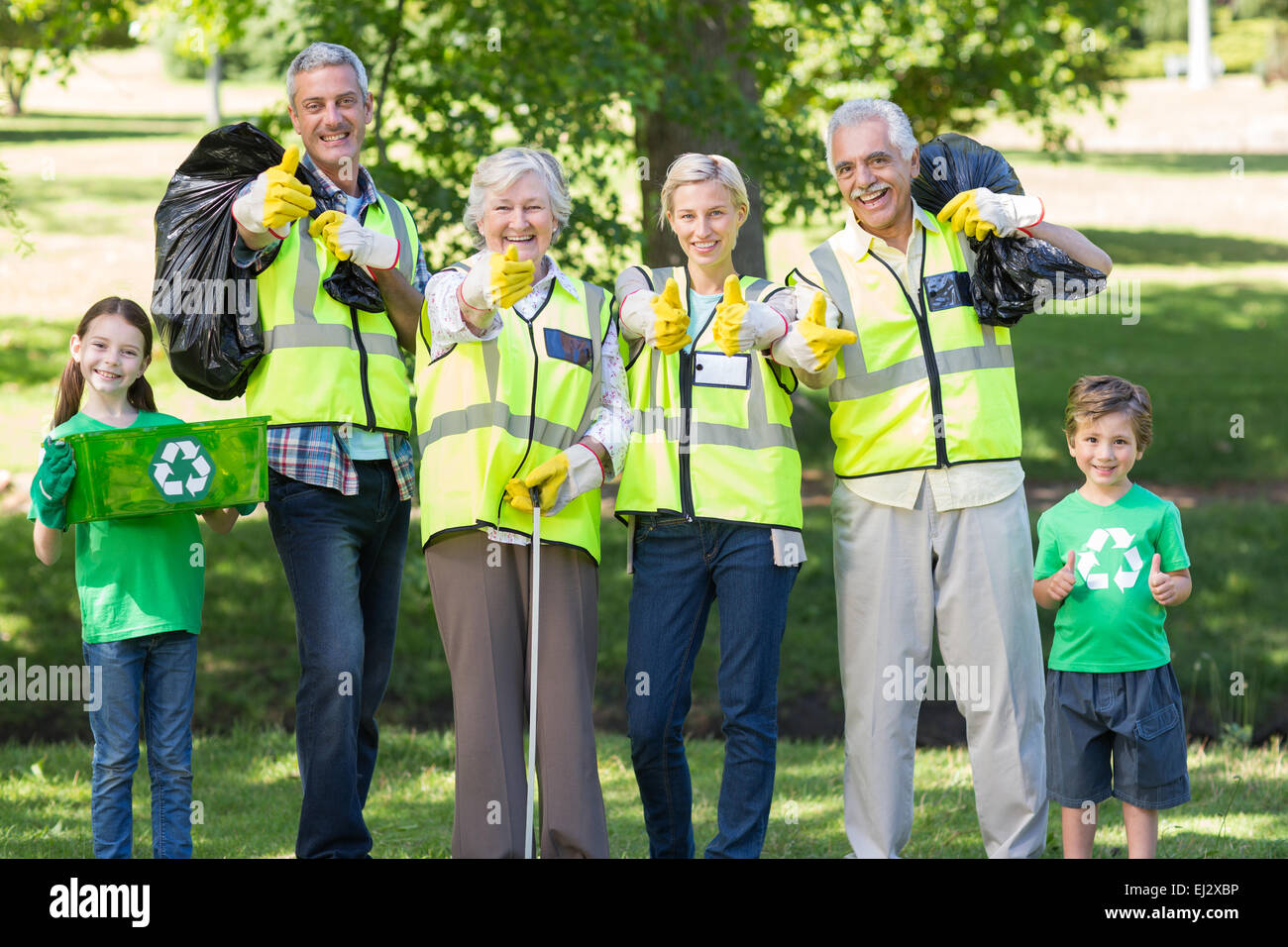Happy family collecting rubbish with thumbs up Stock Photo - Alamy