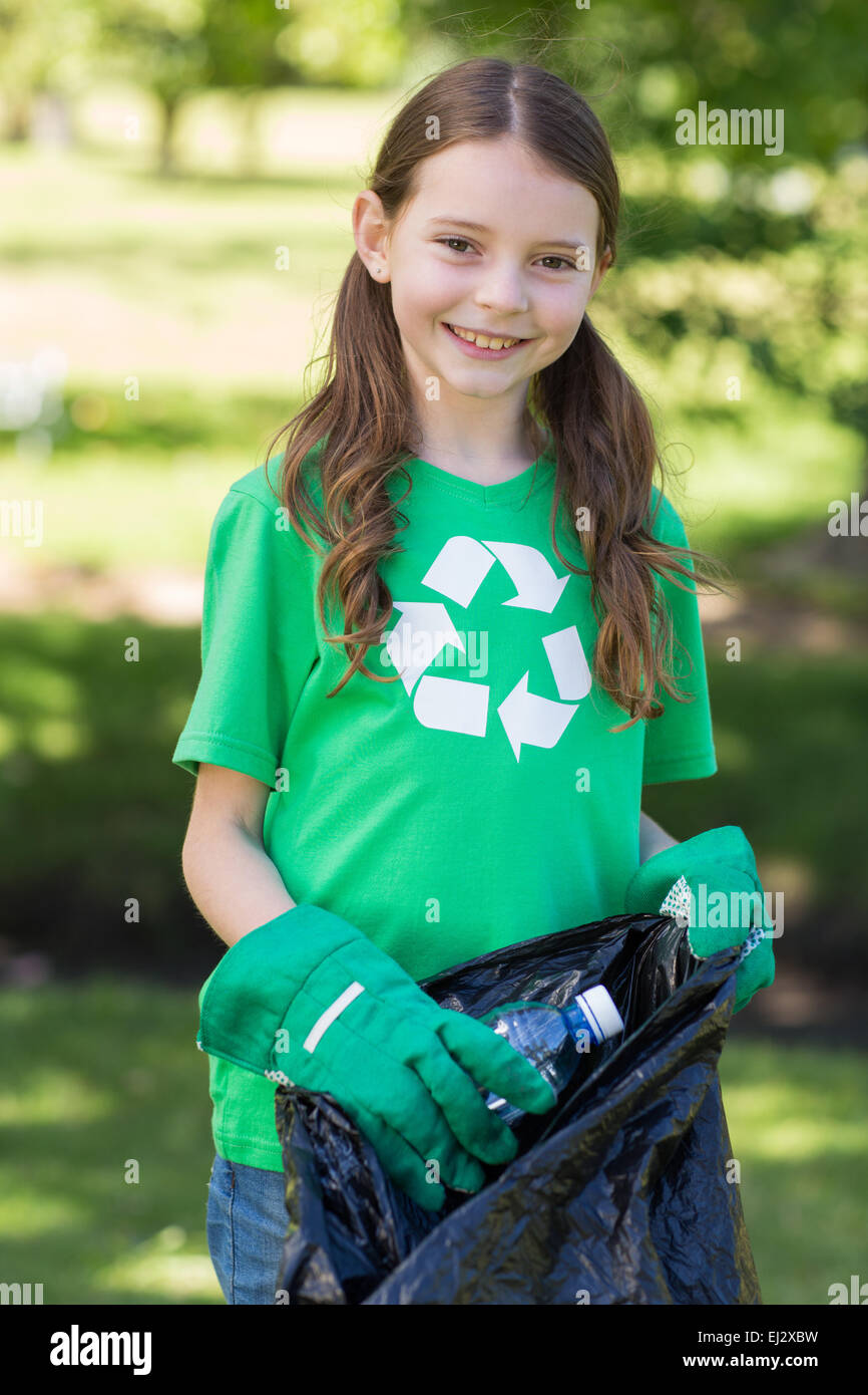 Happy little girl collecting rubbish Stock Photo - Alamy