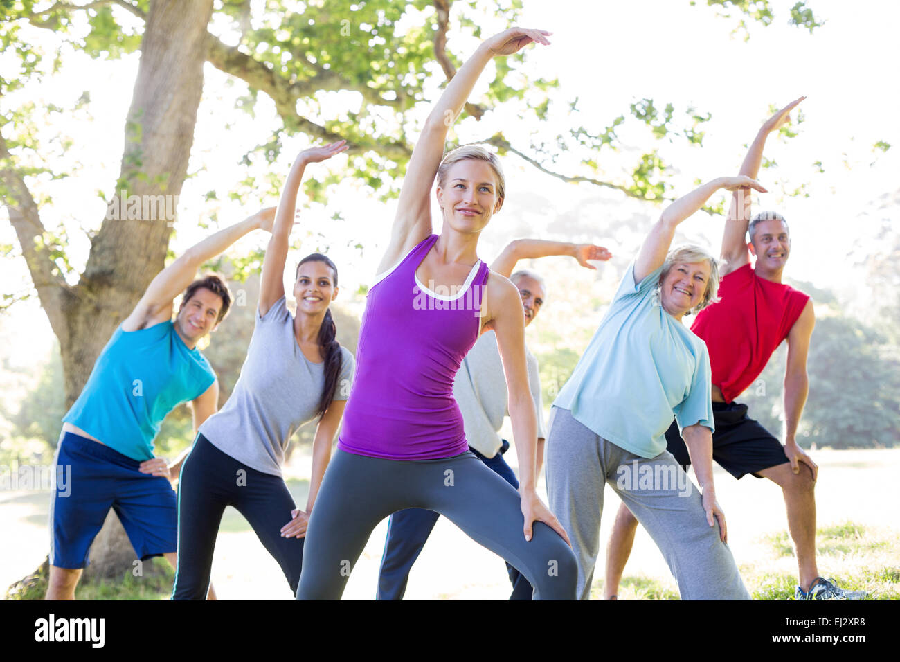 Happy athletic group training Stock Photo - Alamy