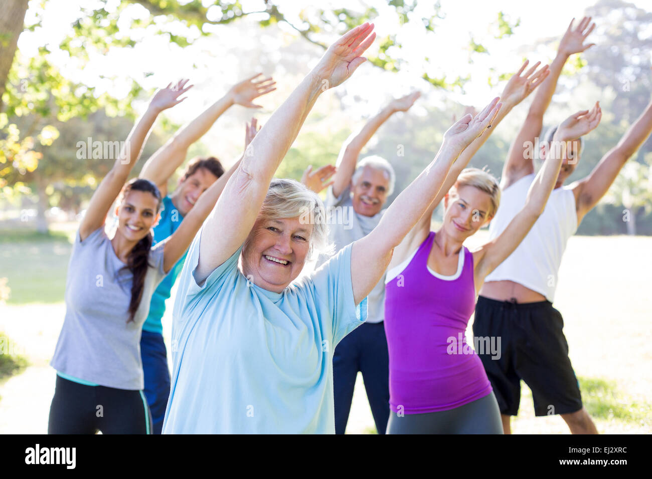 Happy athletic group training Stock Photo - Alamy