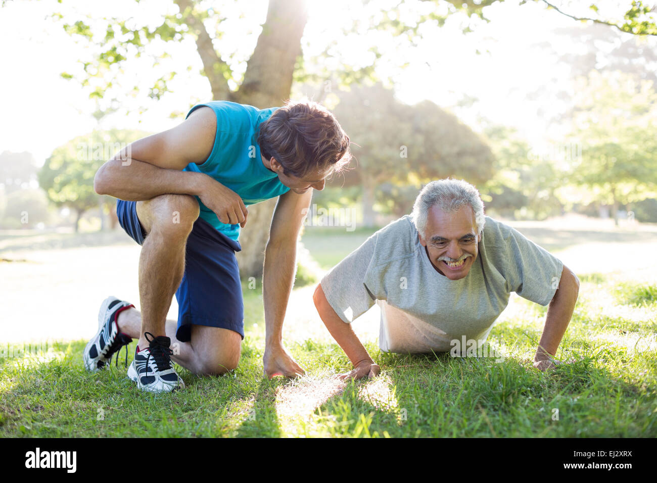 Happy senior training with a coach Stock Photo - Alamy