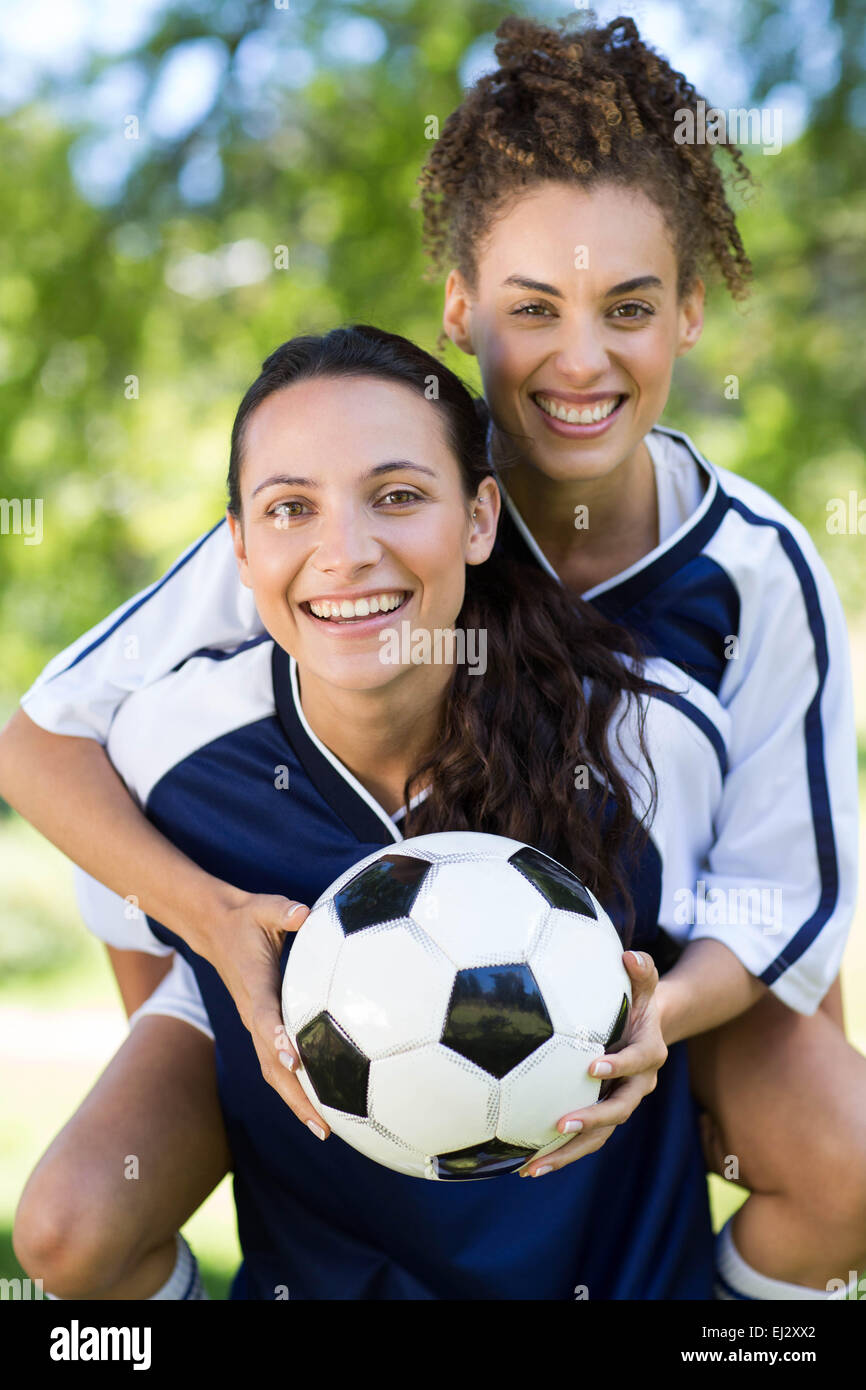 Adult friends playing football park hi-res stock photography and images ...