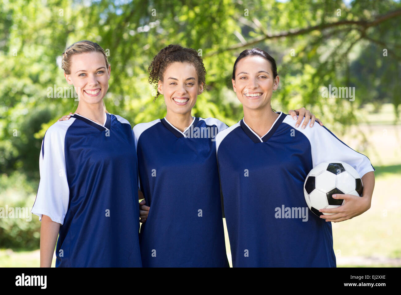 Pretty football players smiling at camera Stock Photo - Alamy