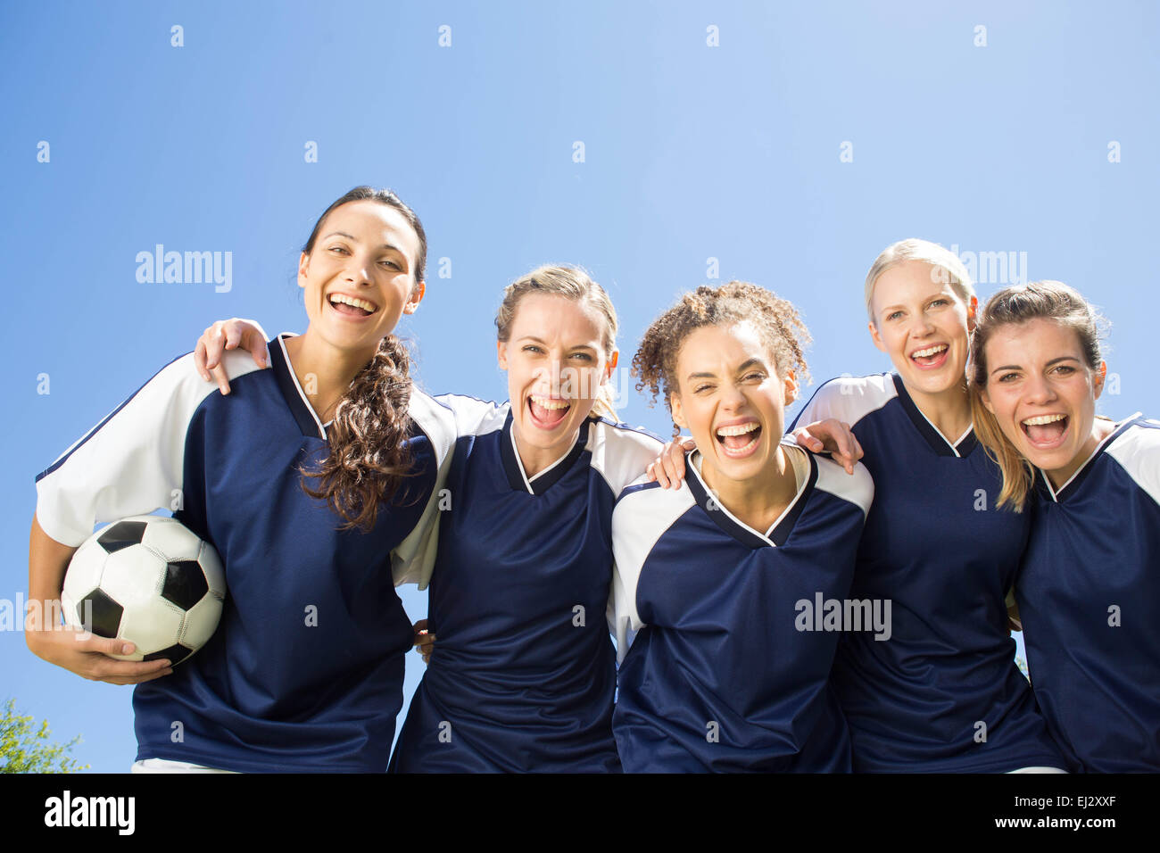 Pretty football players smiling at camera Stock Photo - Alamy