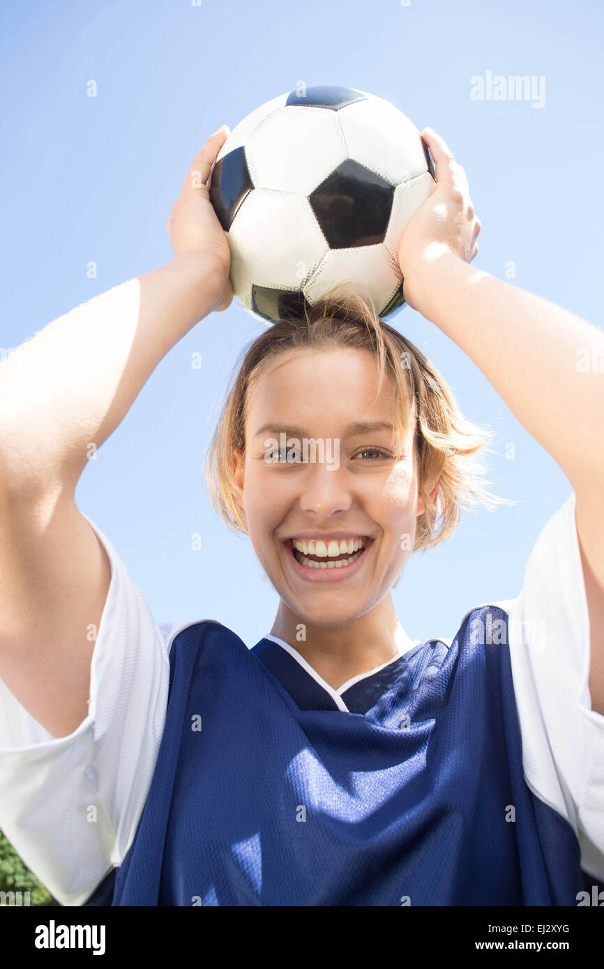 Pretty football player smiling at camera Stock Photo - Alamy